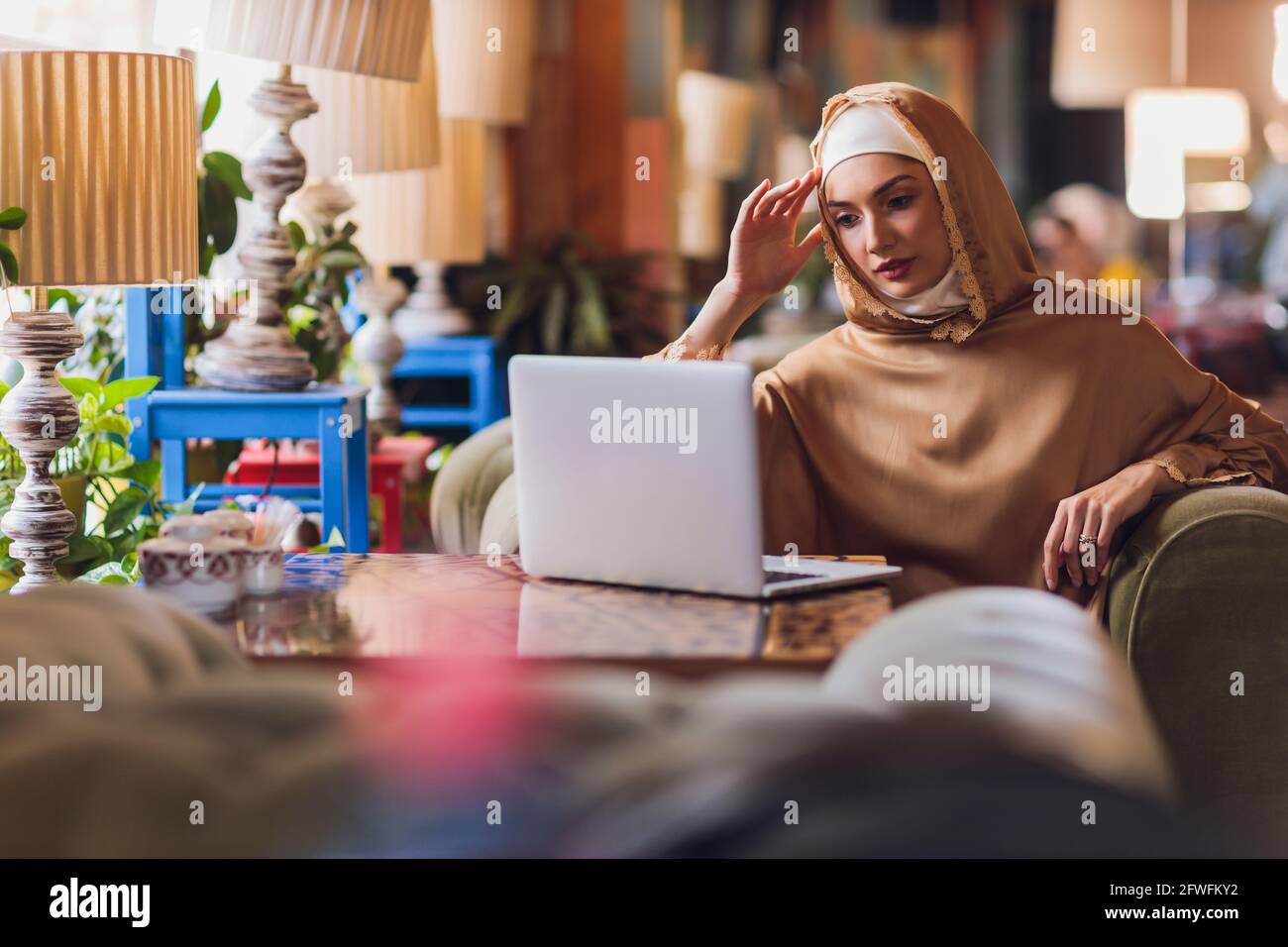 Beautiful Arabic business woman working on computer Stock Photo - Alamy