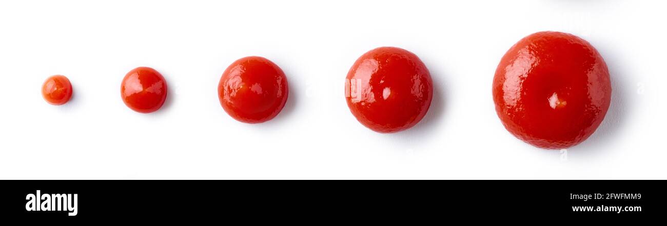 Different sized drops of ketchup isolated on white background, top view ...