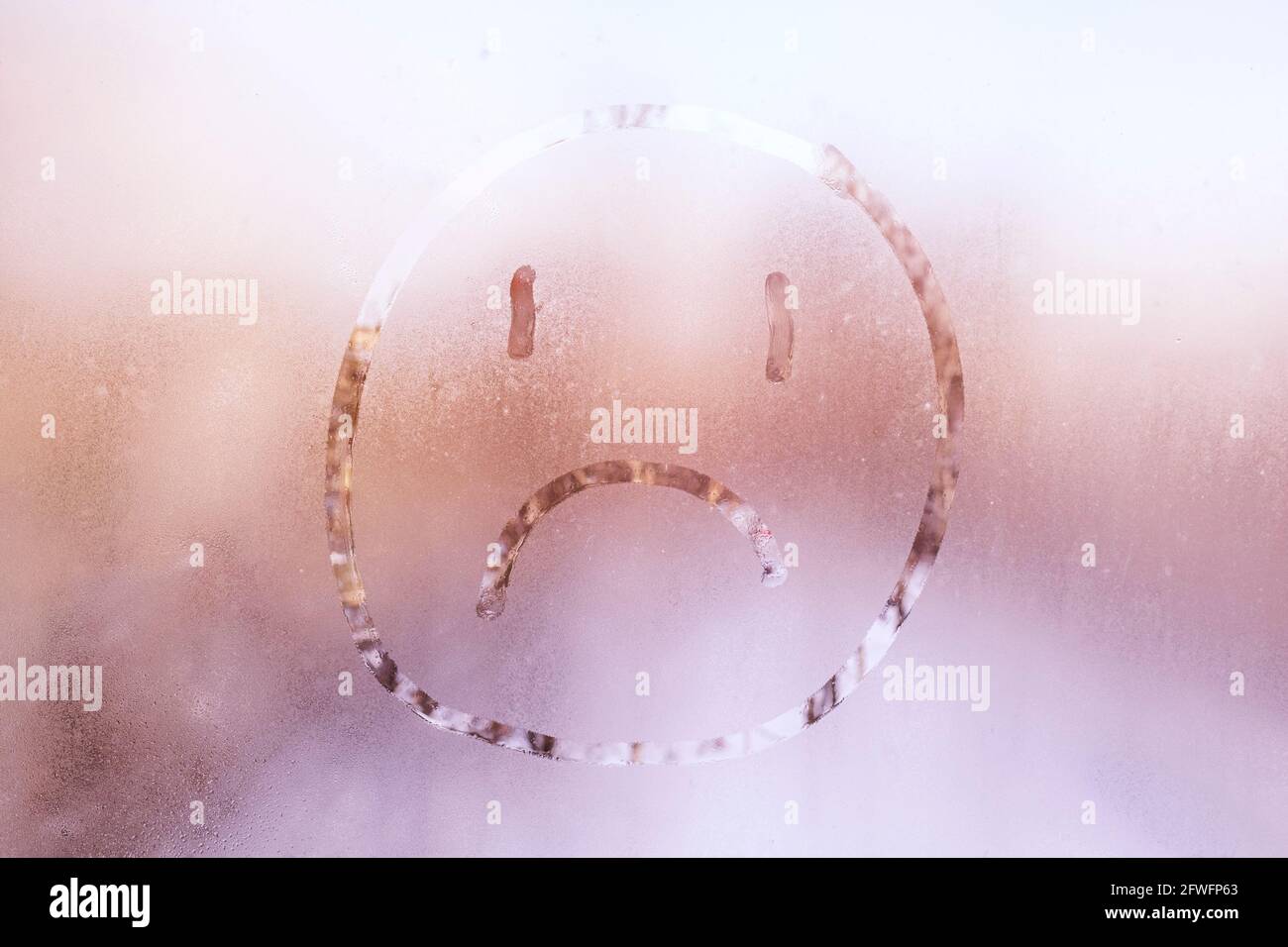 sad face on a wet window glass Stock Photo - Alamy