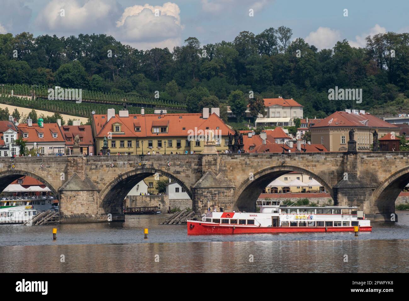 View of the famous Charles bridge prague with tourist boats in the ...