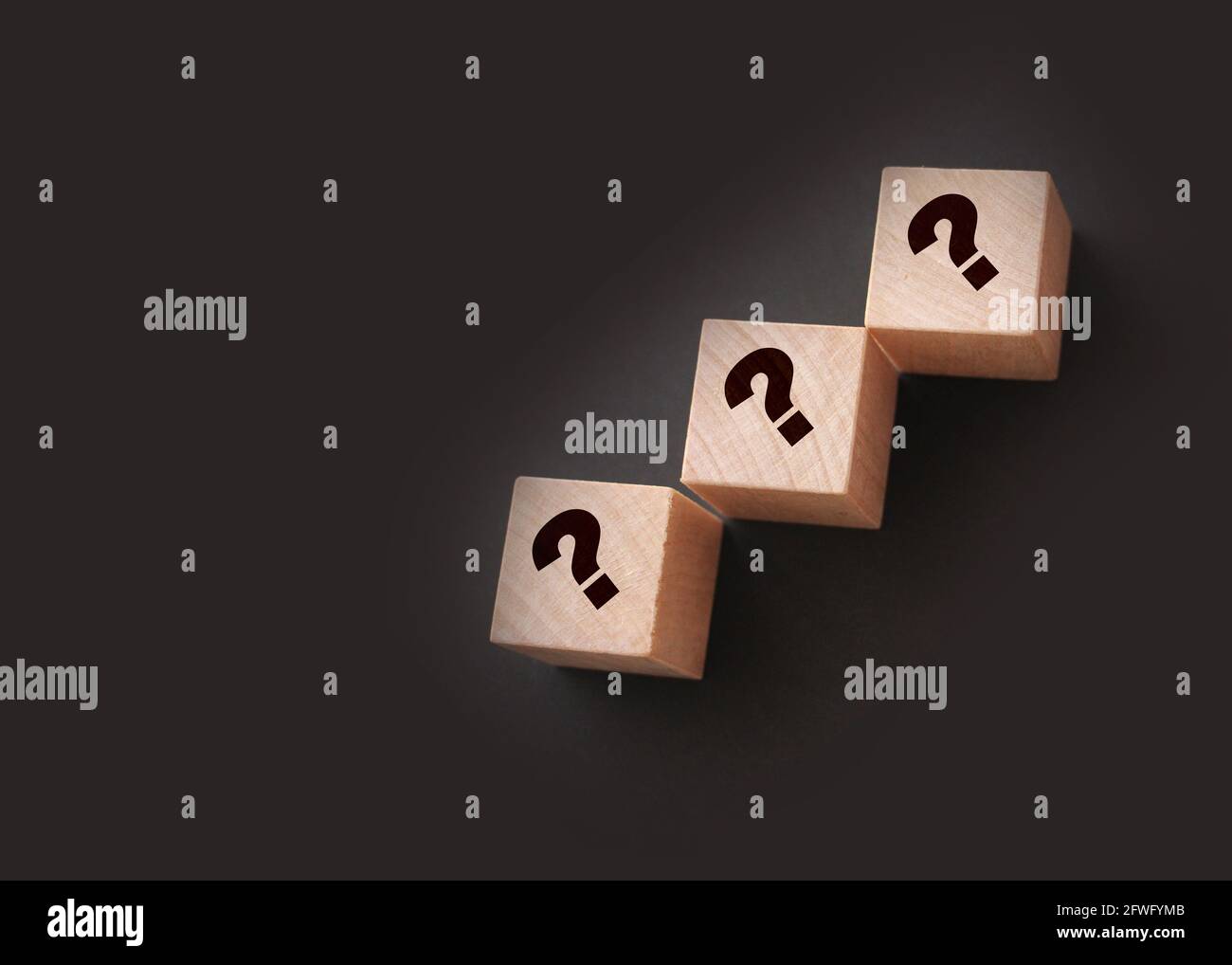 Three wooden blocks with black question marks. Faq questions and ...