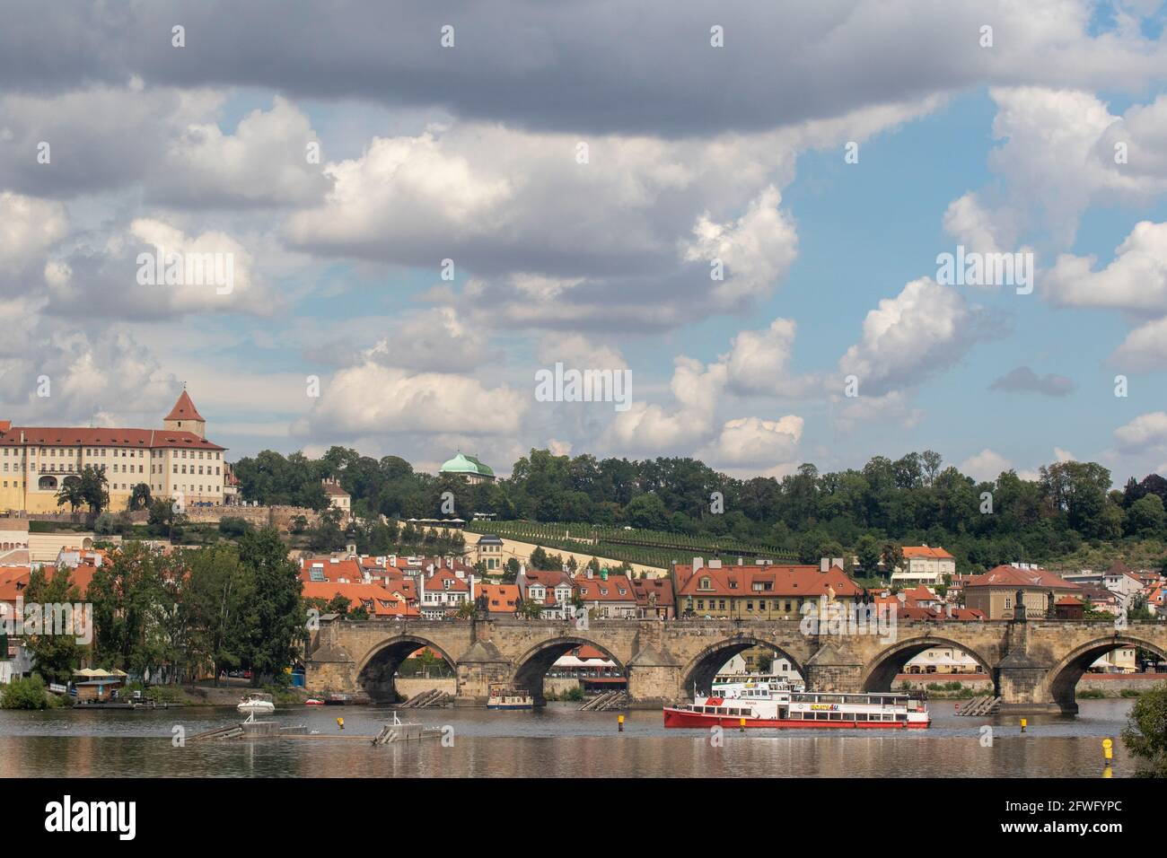 View of the famous Charles bridge prague with tourist boats in the ...