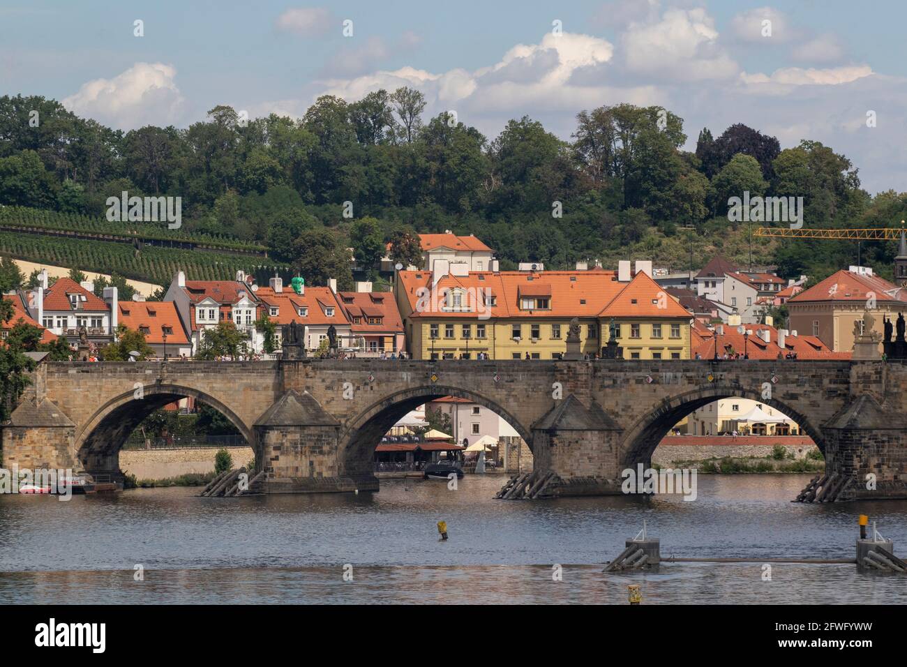 View of the famous Charles bridge prague with tourist boats in the ...