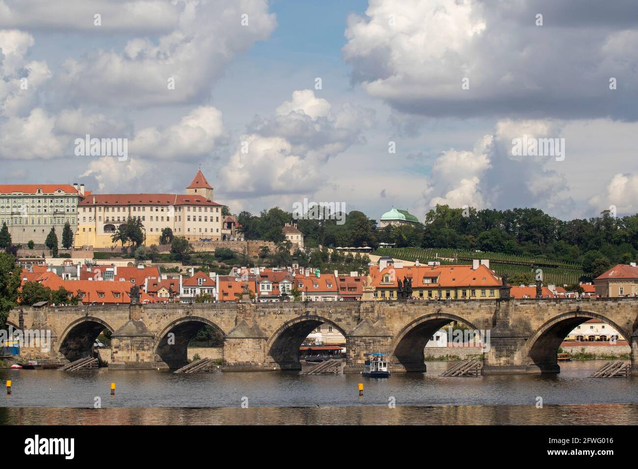 View of the famous Charles bridge prague with tourist boats in the ...