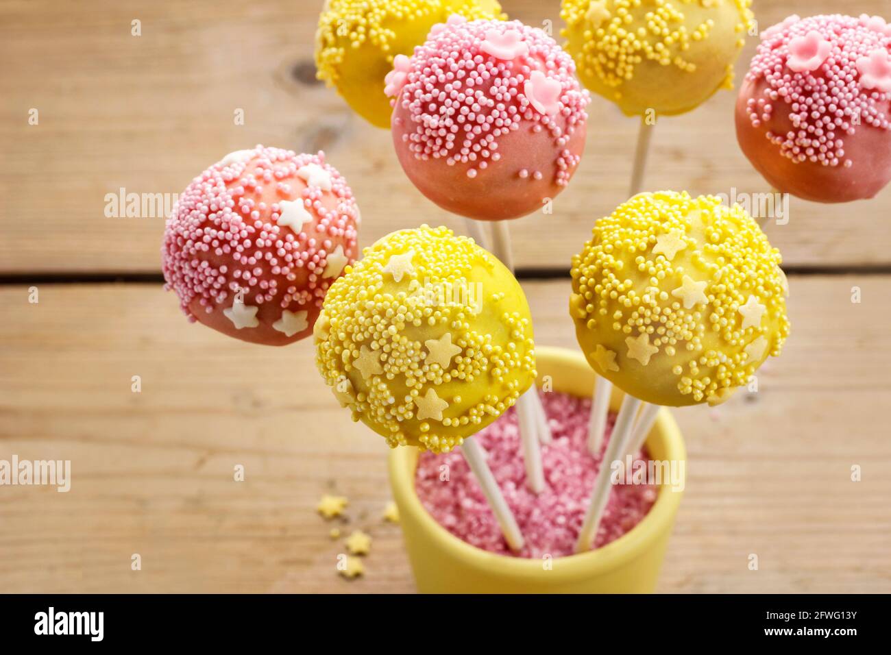 Pink and yellow cake pops. Party dessert Stock Photo - Alamy