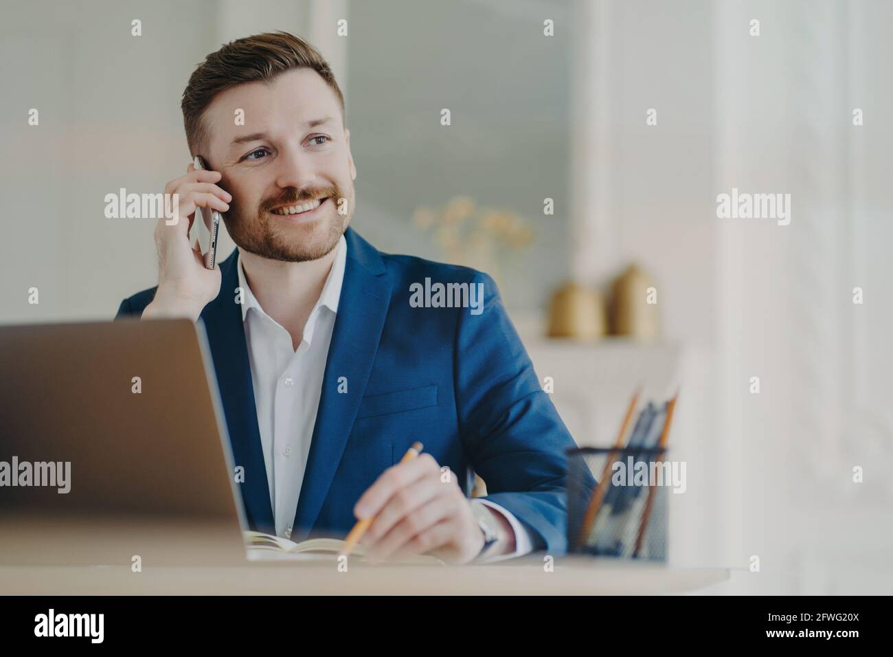 Handsome boss in office hi-res stock photography and images - Alamy