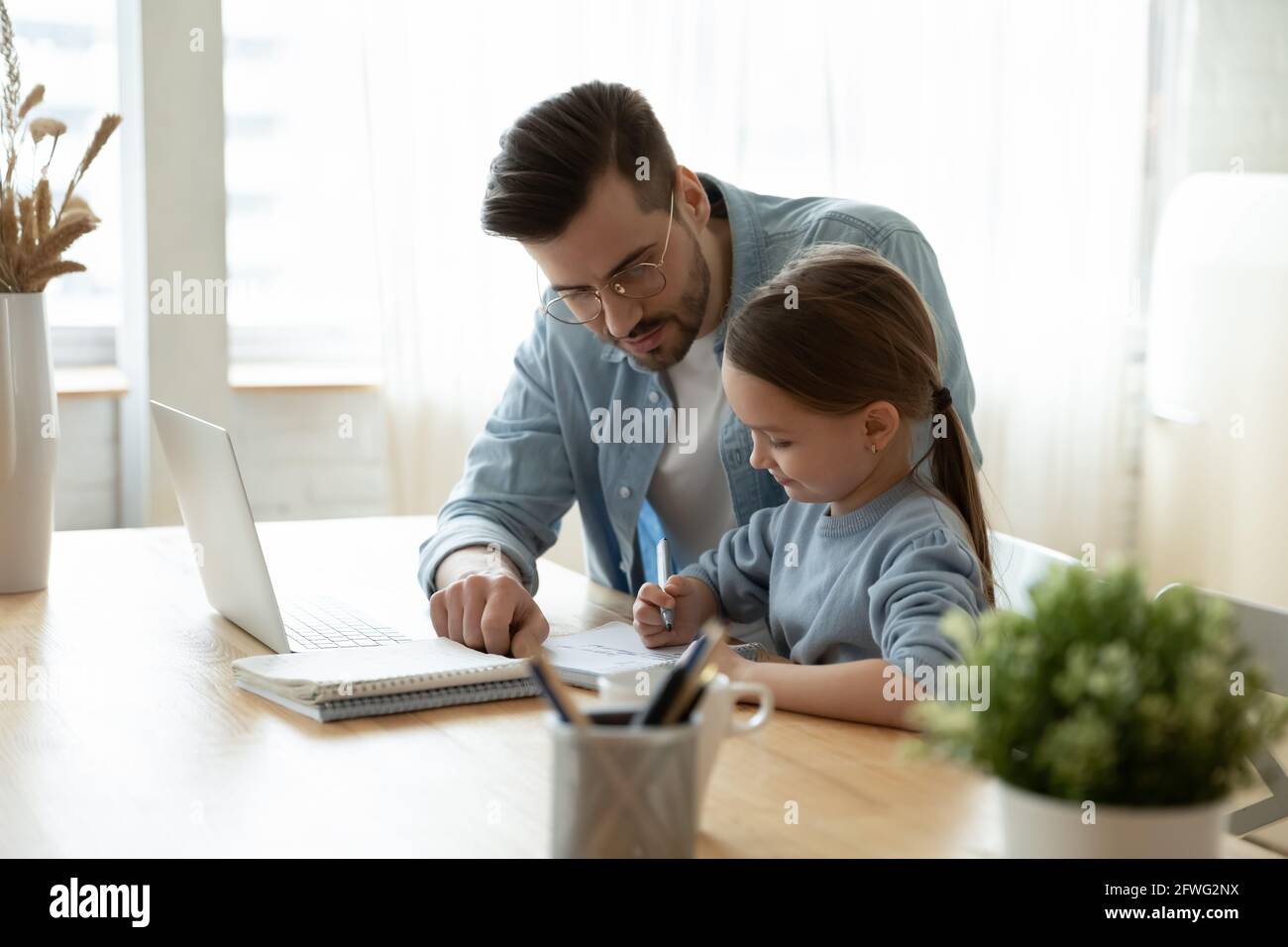 Caring father help little daughter with homework Stock Photo - Alamy
