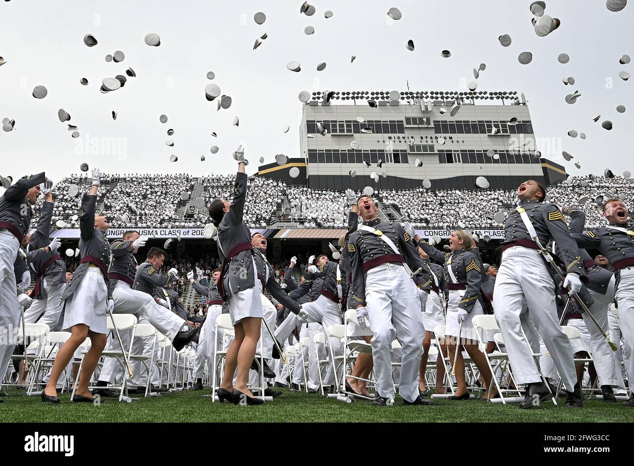 West Point graduates toss their hats in the air at the conclusion of ...