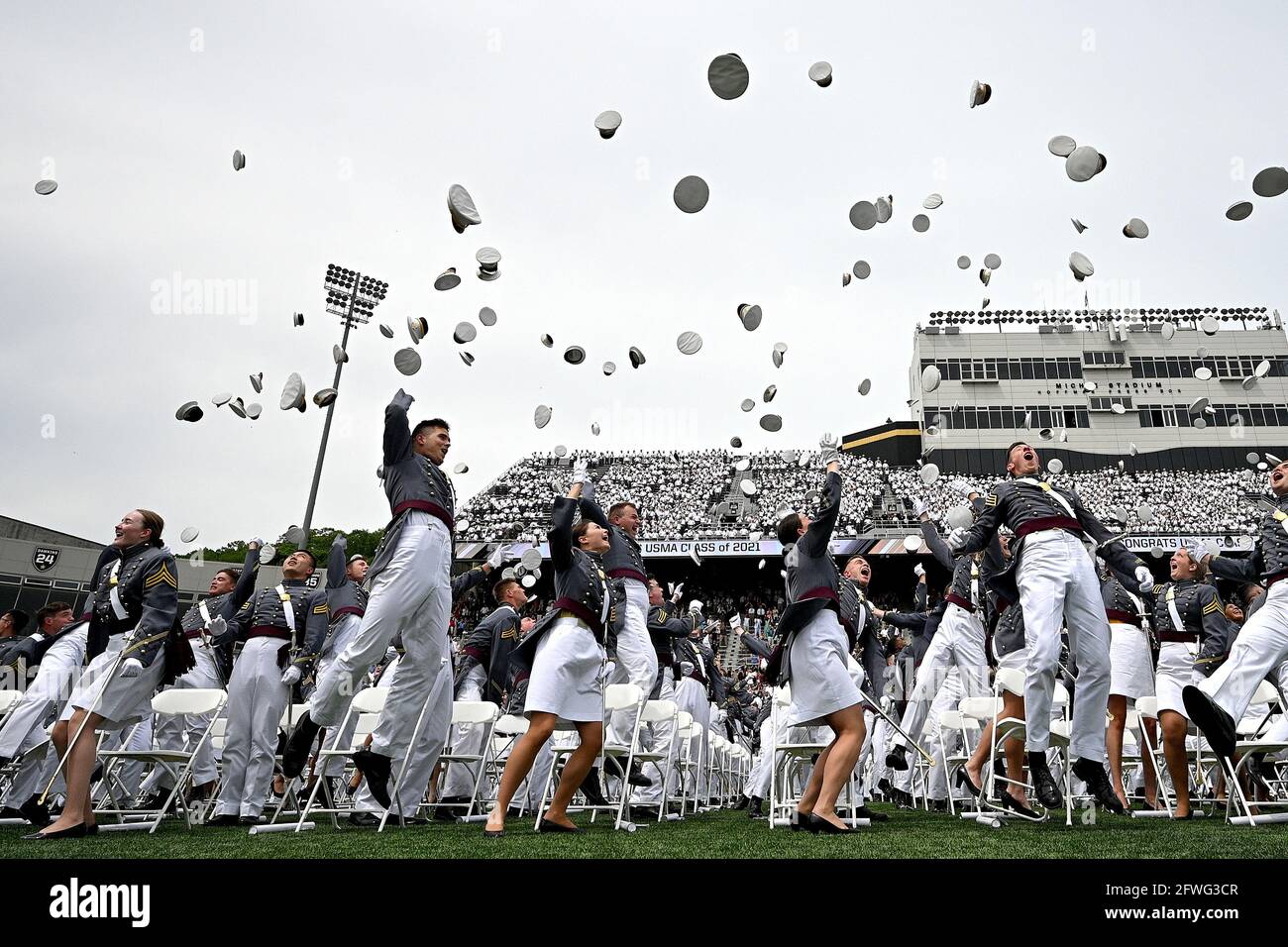 West Point graduates toss their hats in the air at the conclusion of ...