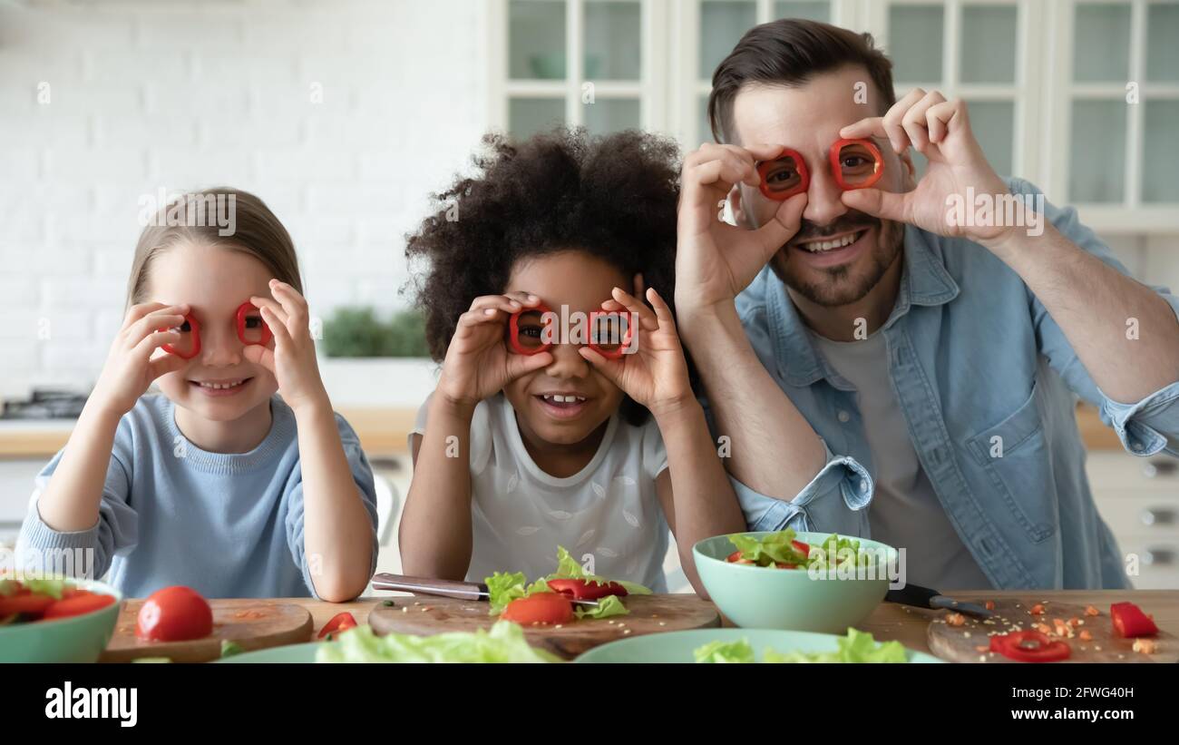 Portrait of happy dad cook with multiracial daughters Stock Photo - Alamy