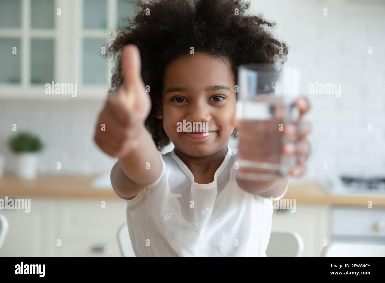 Portrait of happy African American girl child recommend clean water ...