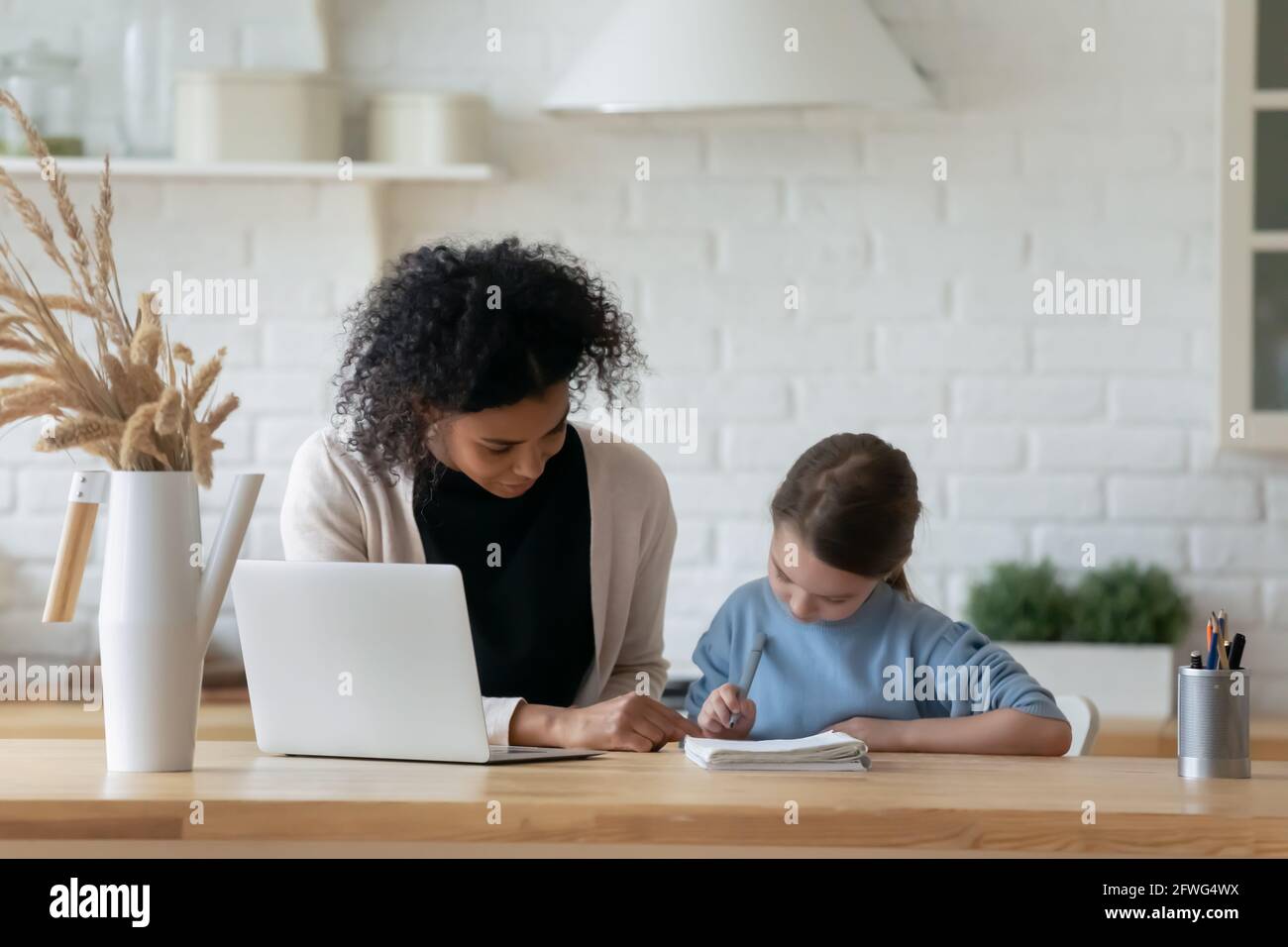Girl doing homework mother using hi-res stock photography and images ...
