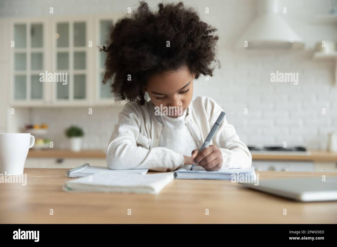 African American little girl study alone at home Stock Photo - Alamy