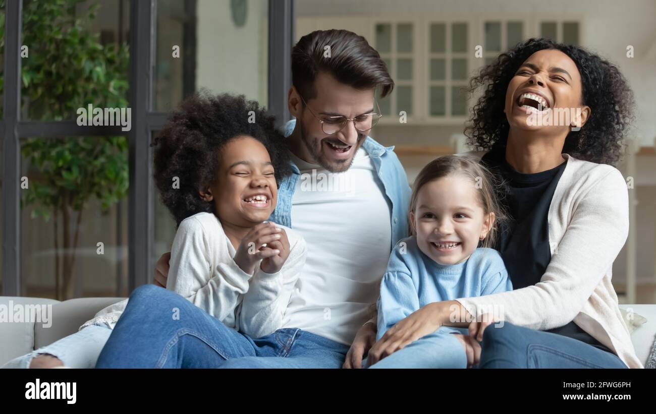 Happy multiracial family with little daughters relax at home Stock ...