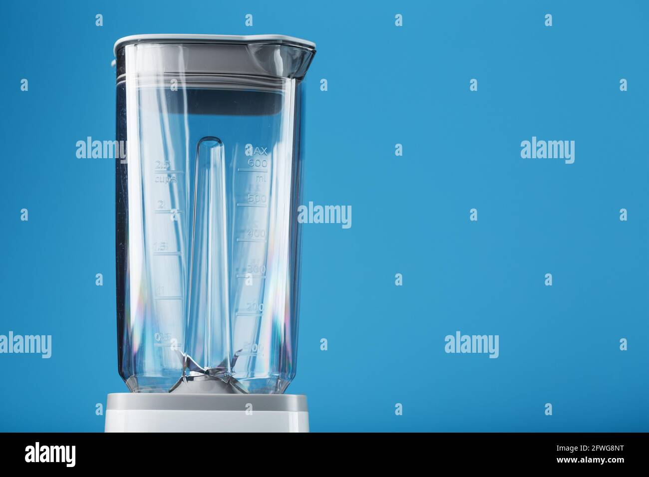 Electric blender with an empty cup on a blue background. Free space ...