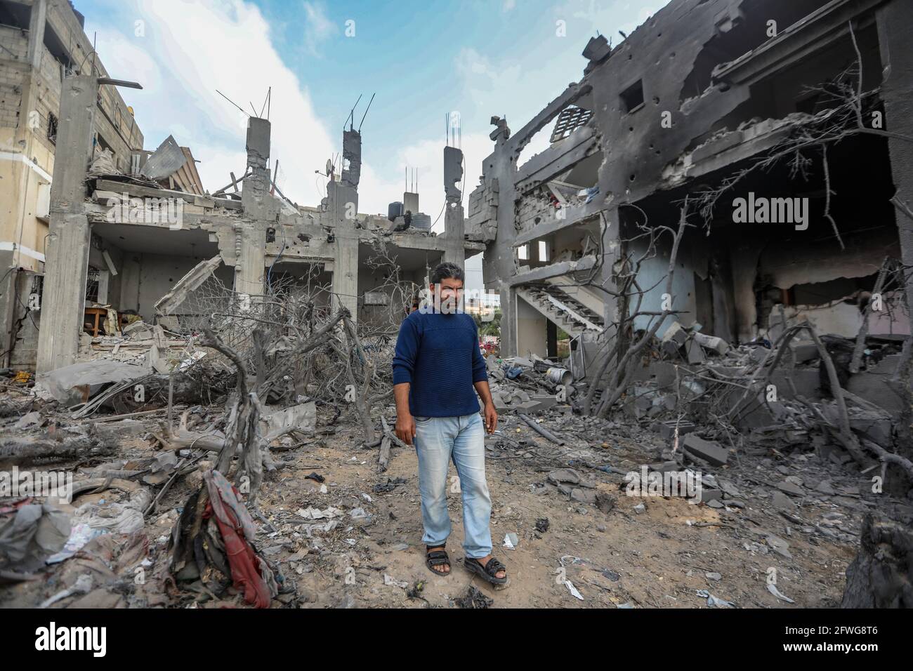 People inspect the rubble of destroyed residential building which was ...