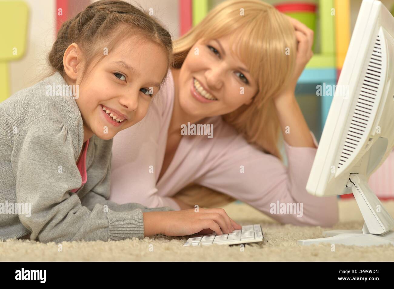 Portrait of mother and daughter using computer Stock Photo - Alamy