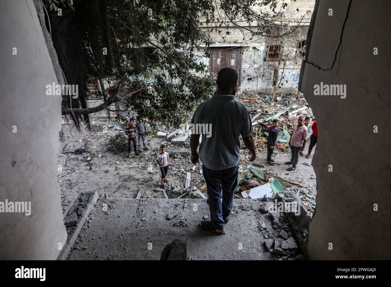 People inspect the rubble of destroyed residential building which was ...