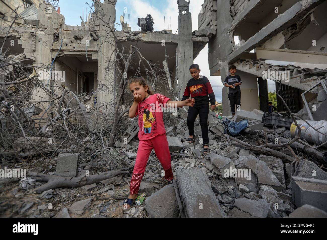 Children near a destroyed residential building which was hit by Israeli ...