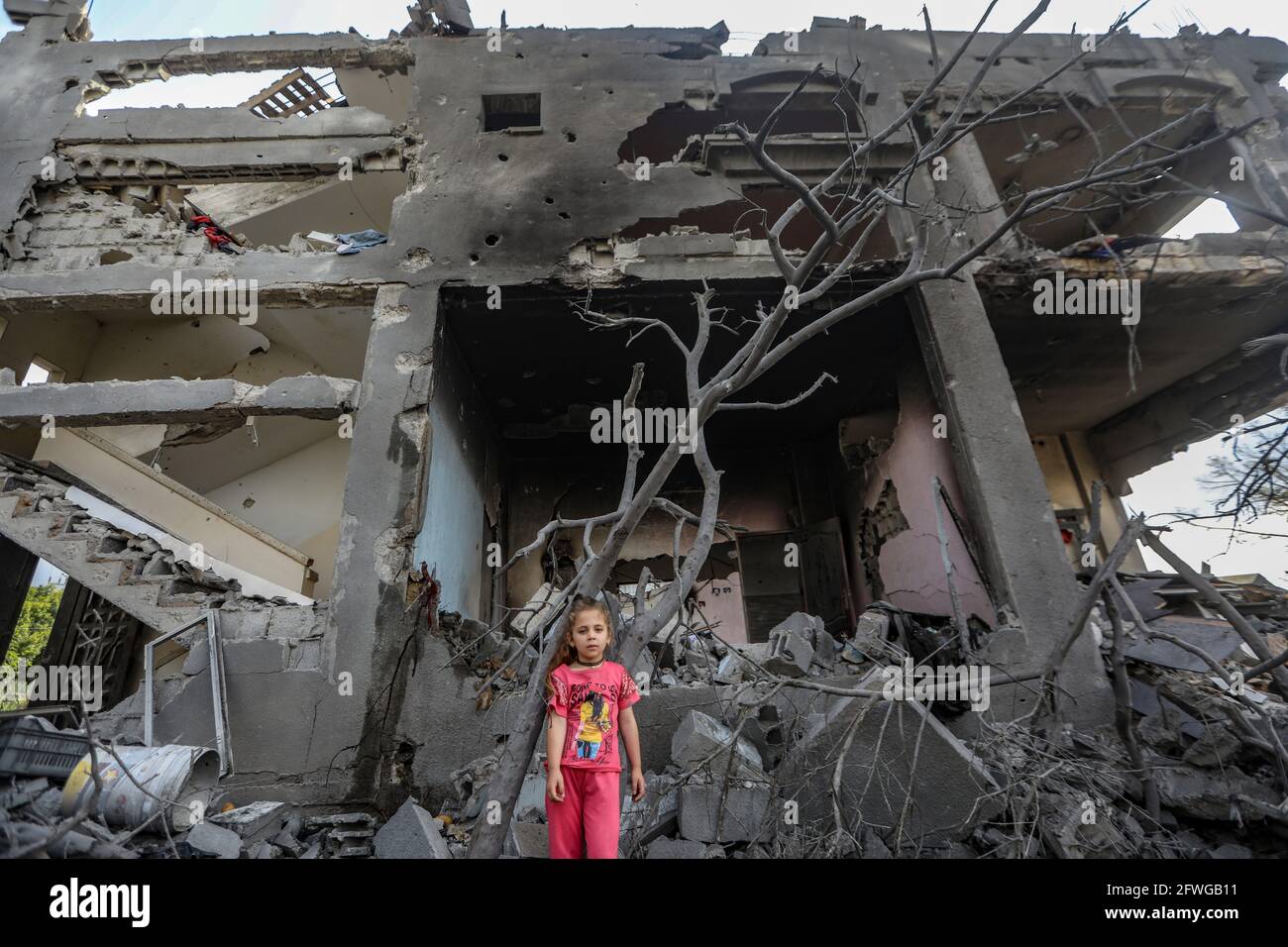 A portrait of a child near a destroyed residential building which was ...