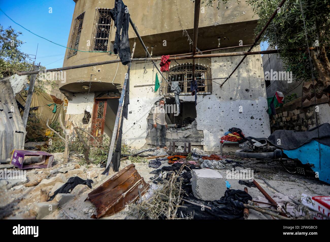 People inspect the rubble of a destroyed residential building which was ...