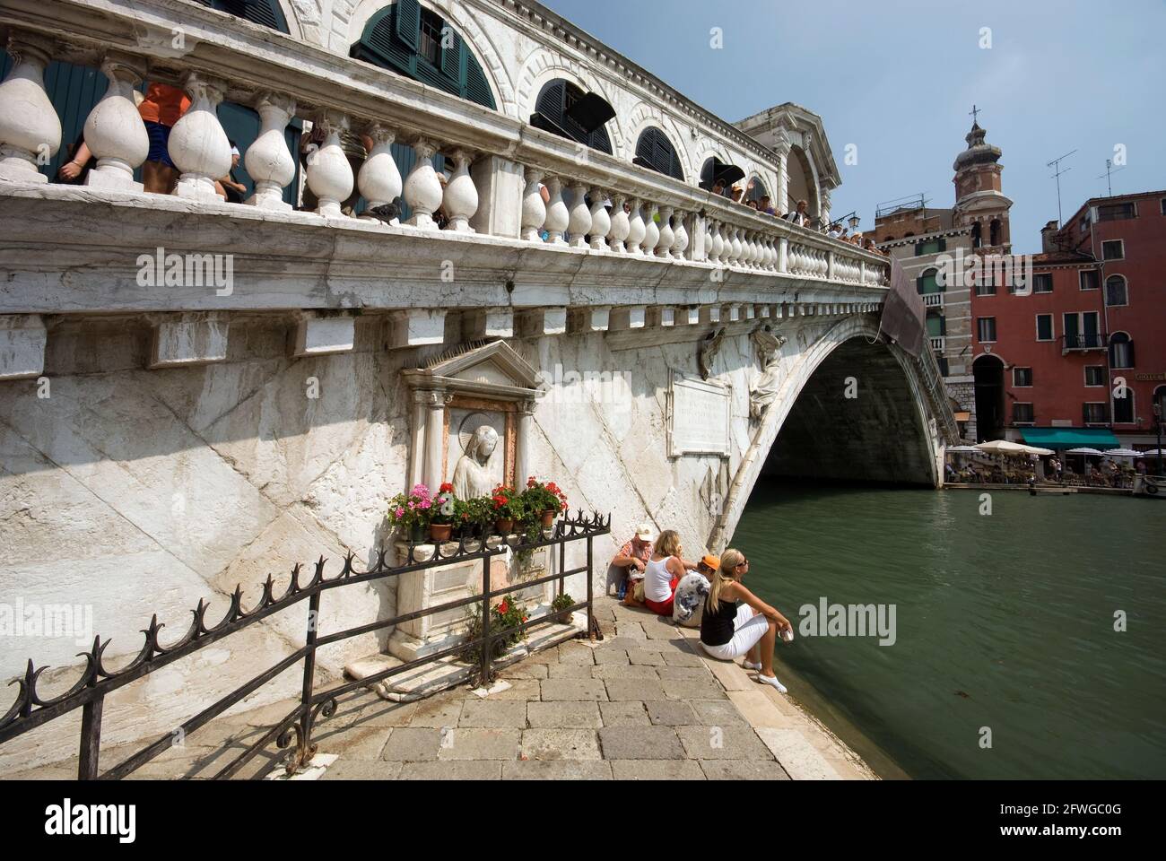 Tourists Sit On The Steps Of The Rialto Bridge In Venice Italy Stock ...