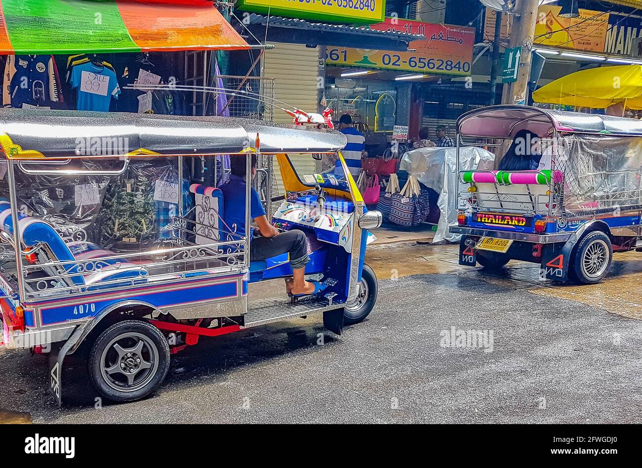 Typical colorful tuk tuks taxis driving people around in Bangkok Thailand Stock Photo - Alamy