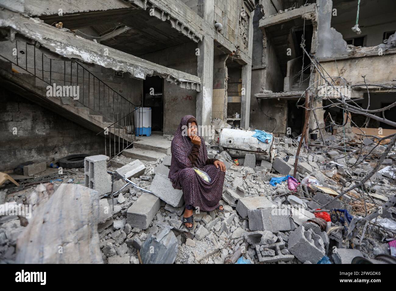 People inspect the rubble of homes and buildings which was hit by ...