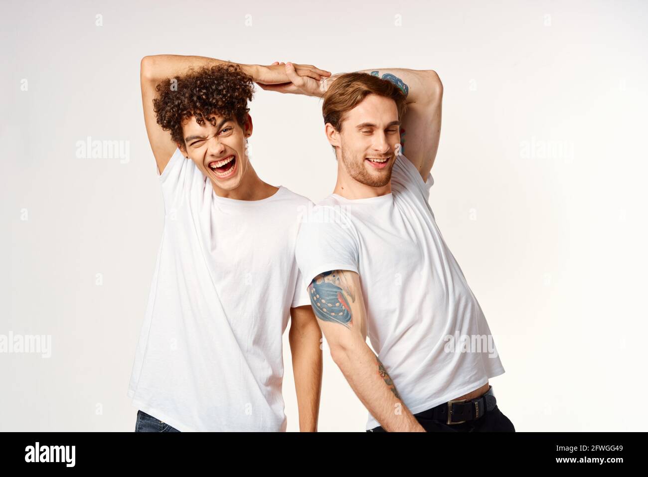 two funny friends in white t-shirts laughing positive emotions Stock ...