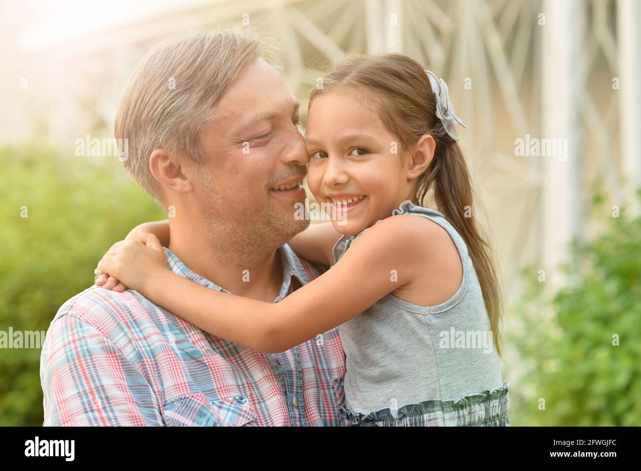 Portrait of happy father and daughter hugging outdoors Stock Photo - Alamy