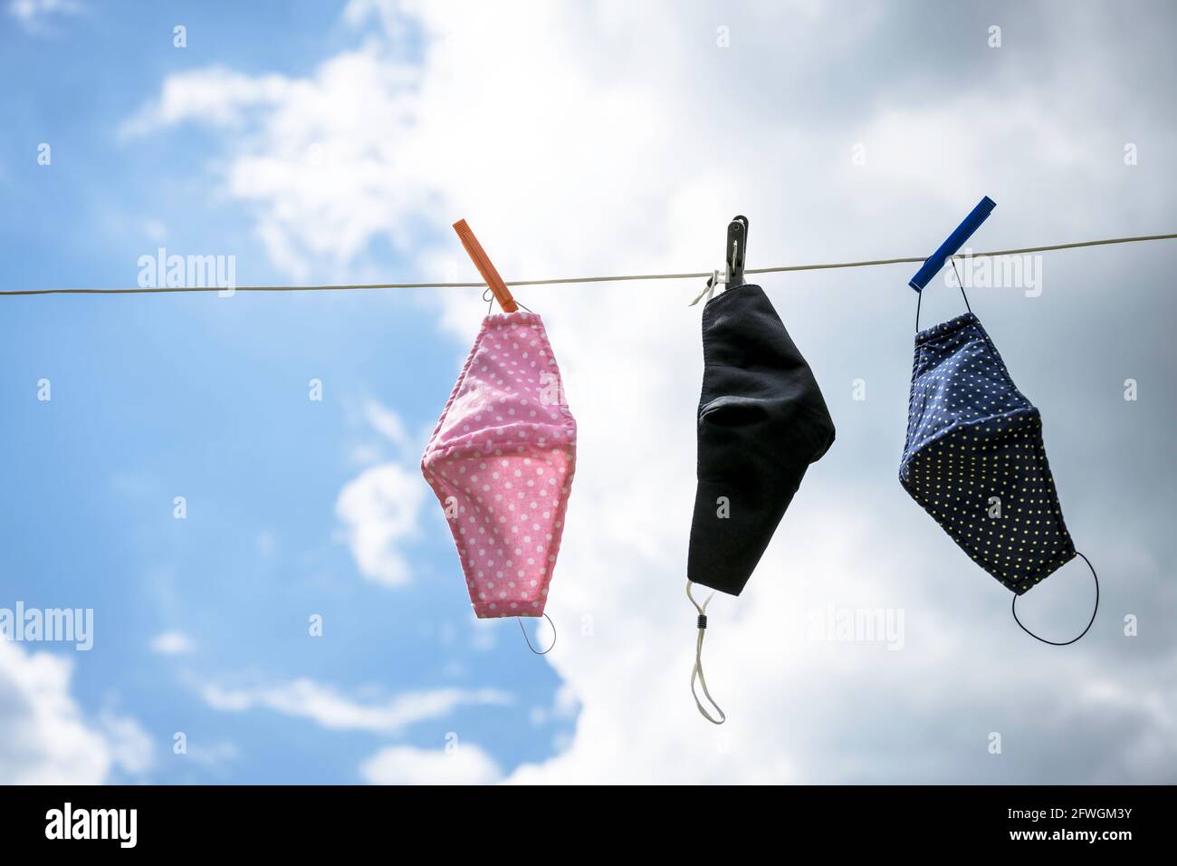Masks hang washing line during panoramic Stock Photo - Alamy