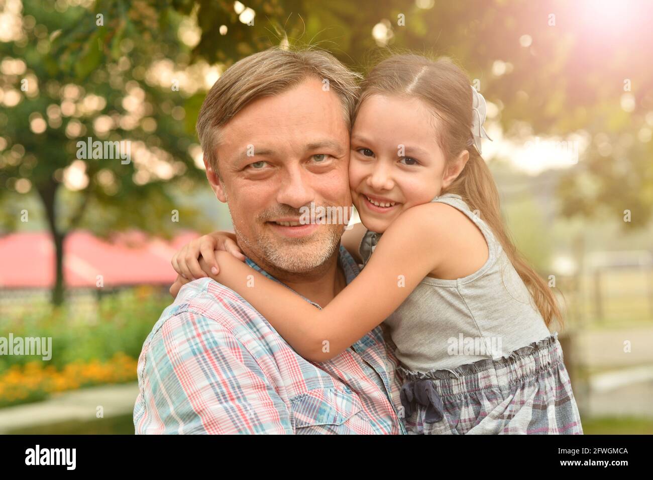 Portrait of happy father and daughter hugging outdoors Stock Photo - Alamy