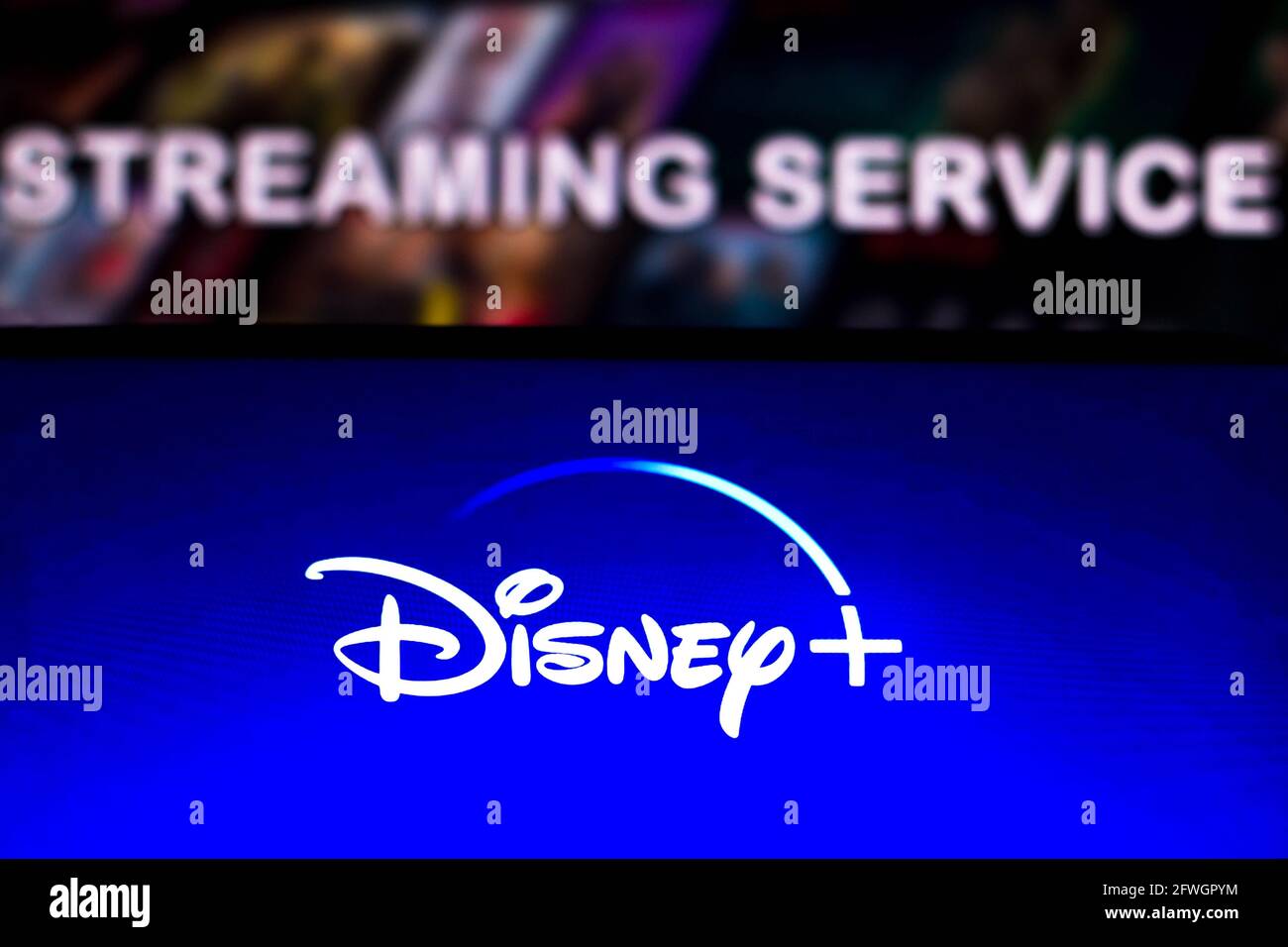 In this photo illustration the Disney + (Plus) logo seen displayed on a ...