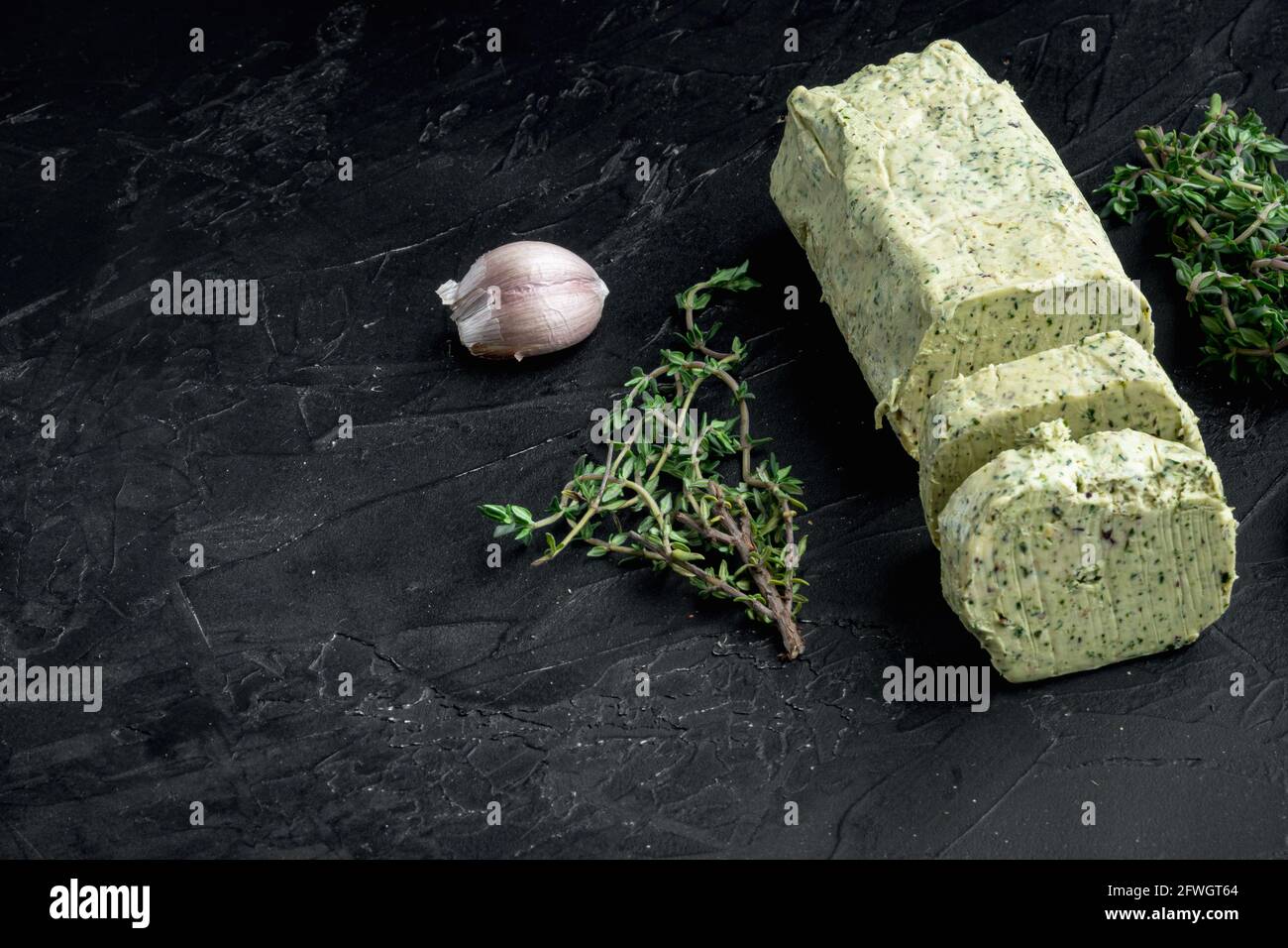 Dairy green butter with herbs set, on black stone background, with copy ...