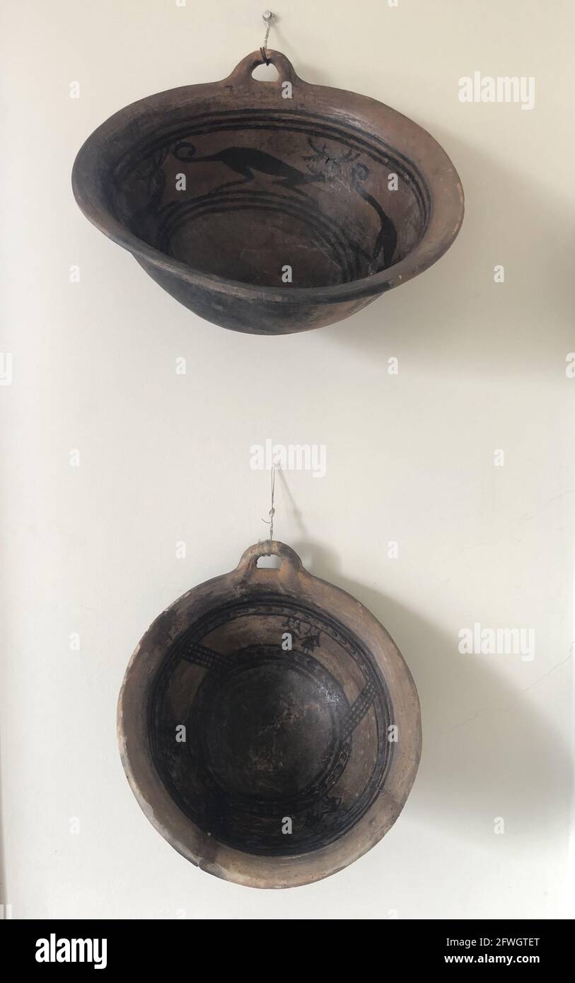 Ancient bowls with patterns hanging on the wall Stock Photo - Alamy