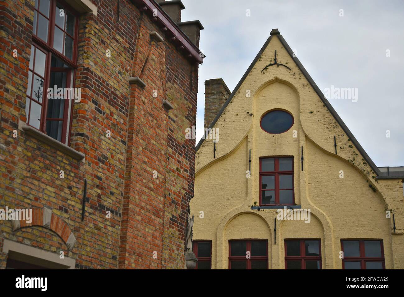 Gothic Revival style building with a brick facade and a pointed clay ...