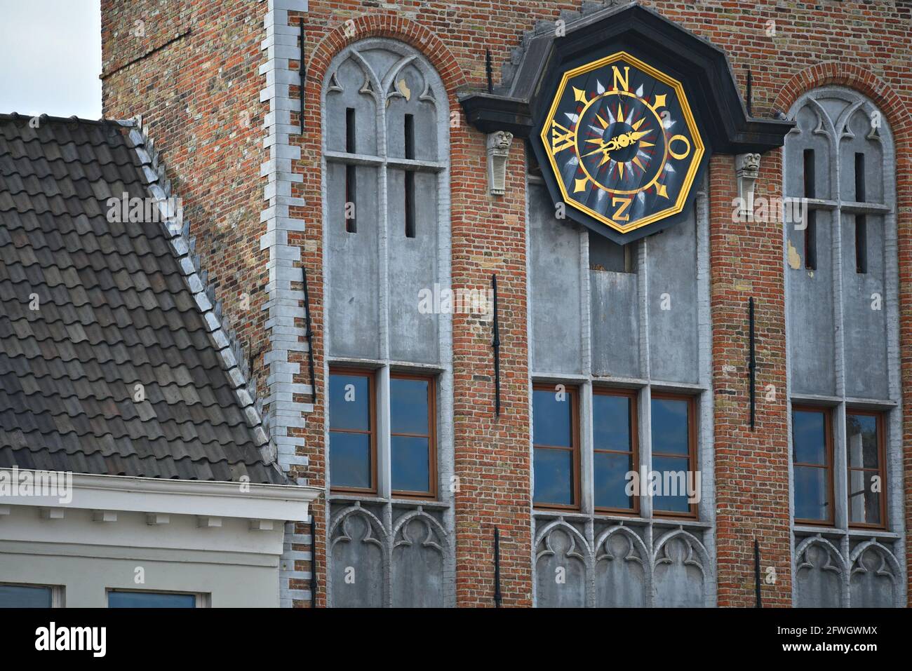 Old vintage hand painted compass on a Gothic style building with a ...