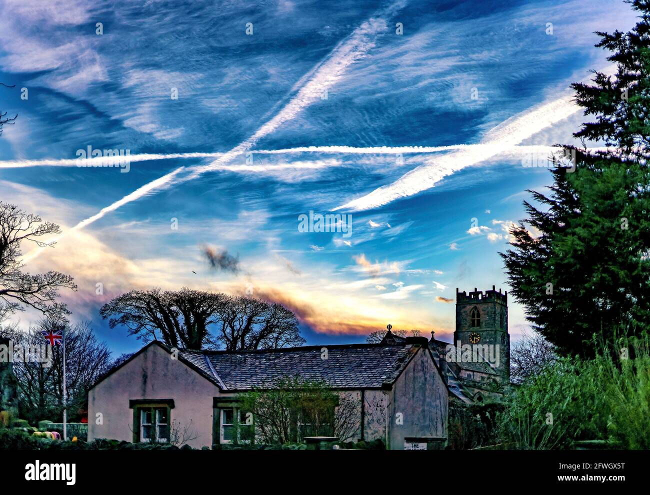 Dramatic sky over Holy Trinity Church in the village of Embleton ...