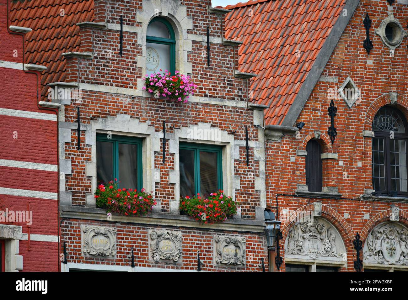 Picturesque Gothic Revival style house with a brick facade, a pointed ...