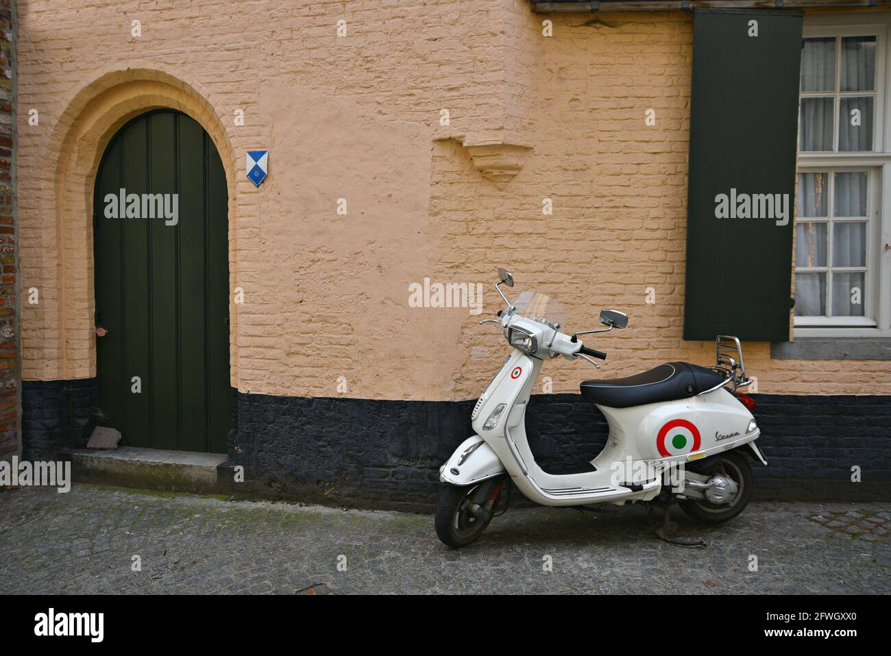 Scenic view of a vintage Vespa parked front of a typical Gothic style ...