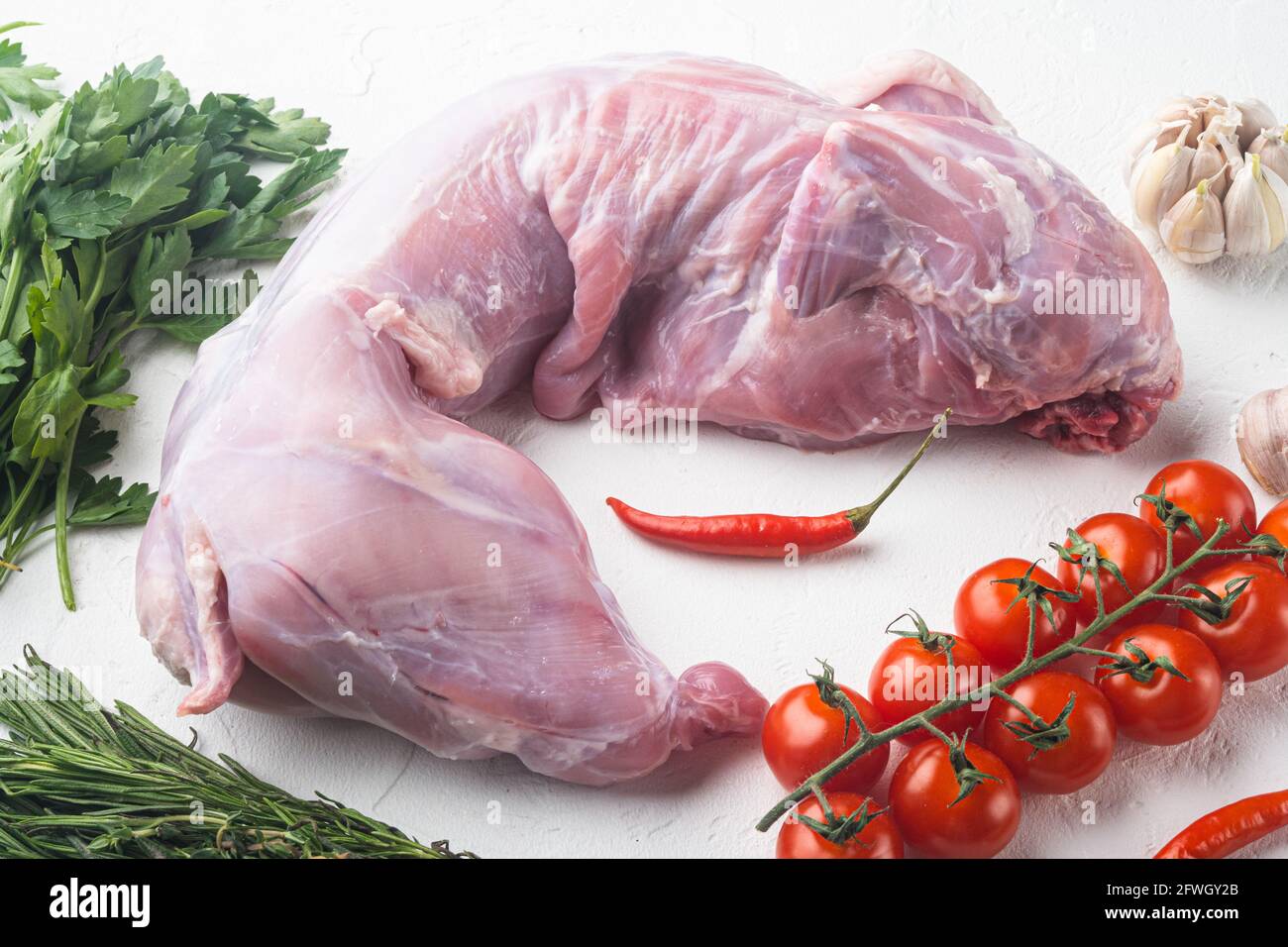 Raw and fresh meat. Whole rabbit ready to cook with ingredients set, on ...