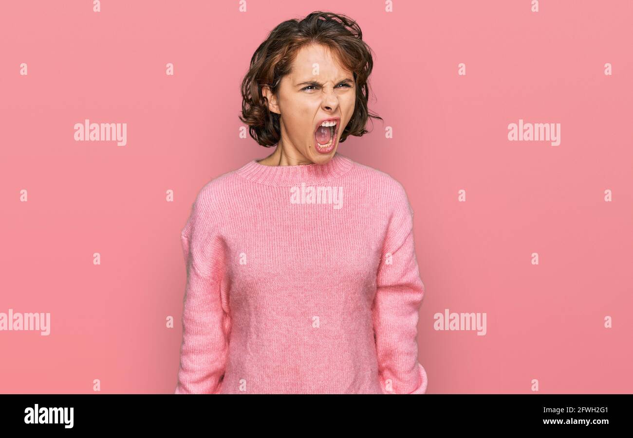 Young hispanic woman wearing casual clothes angry and mad screaming ...