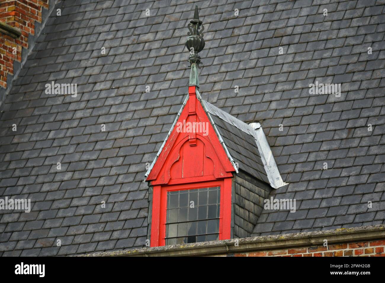 Old Gothic style building shingles rooftop with red attic windows in ...