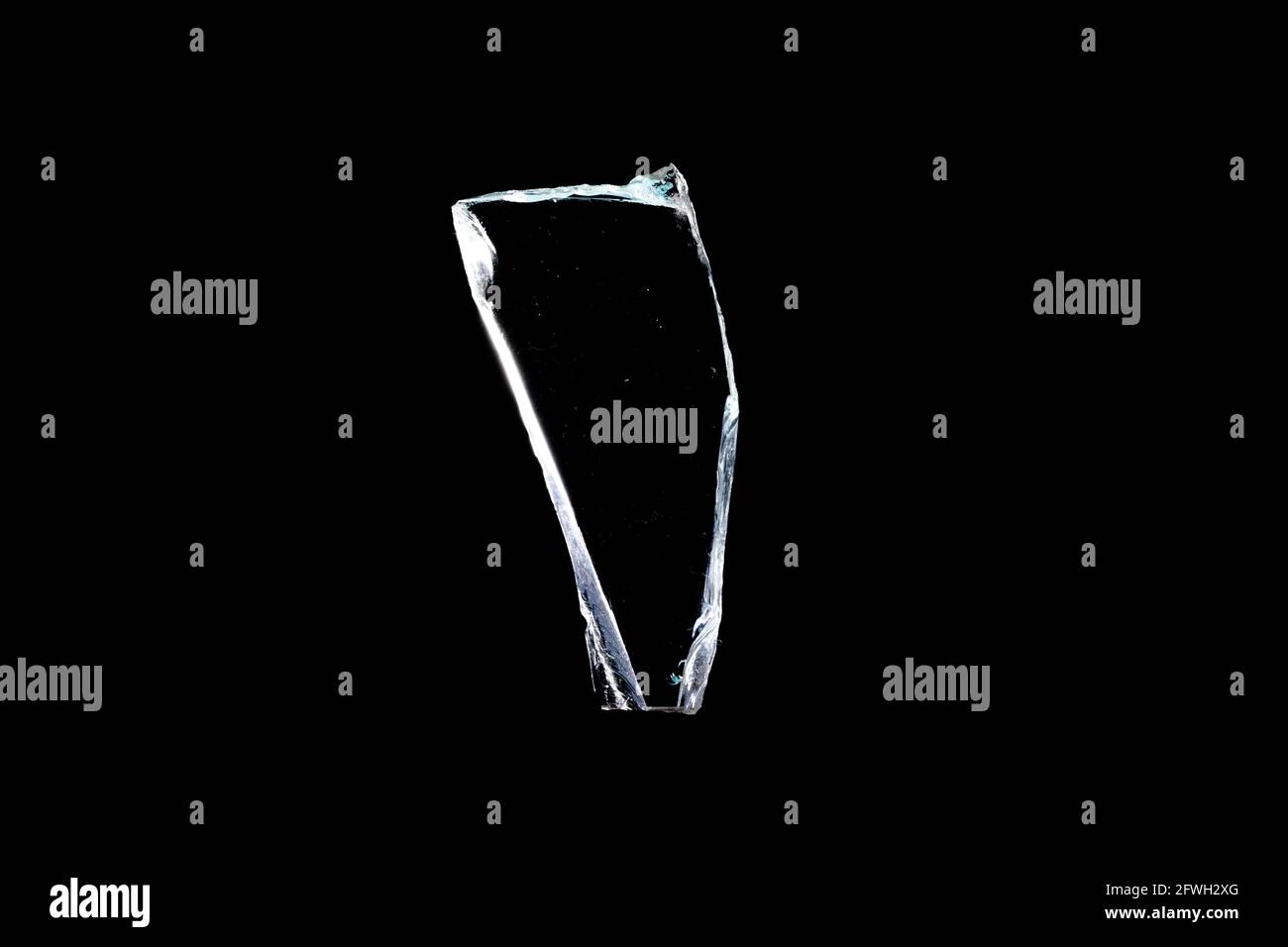 glass fragments in isolation on a black background. damaged window ...