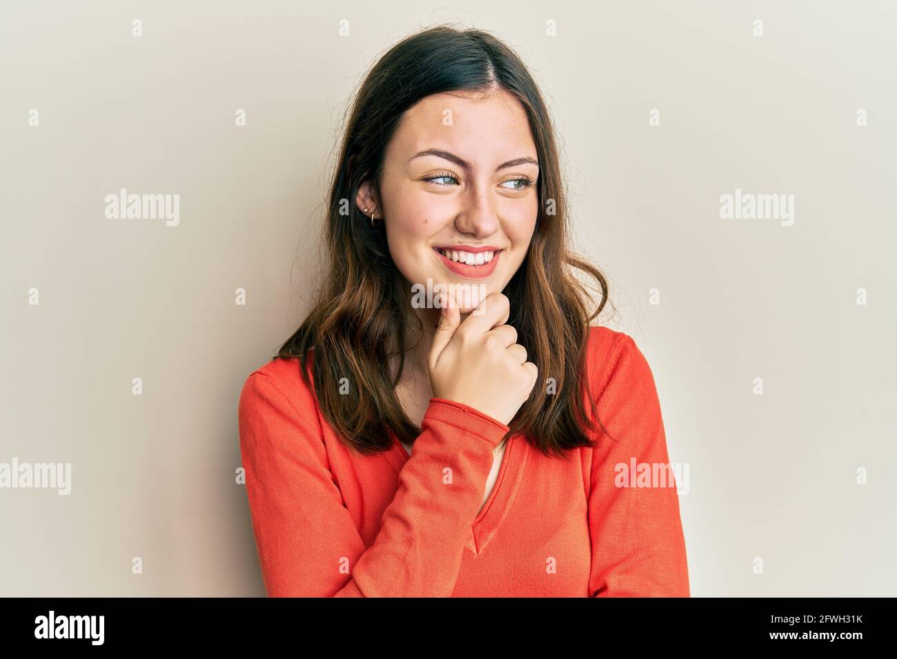Young brunette woman wearing casual clothes with hand on chin thinking ...