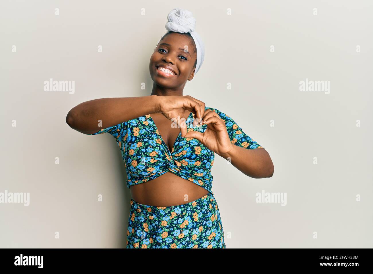 Young african woman wearing hair turban and african style smiling in ...