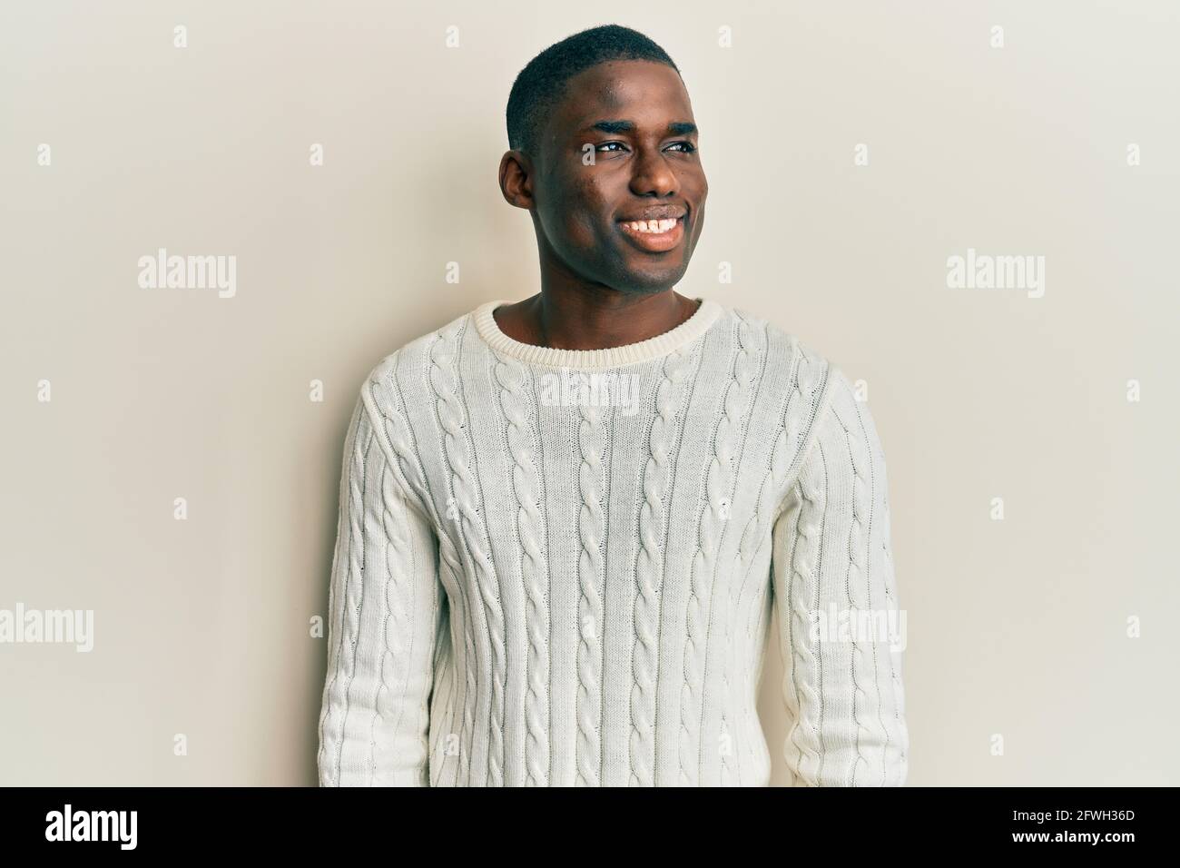 Young african american man wearing casual clothes looking away to side ...