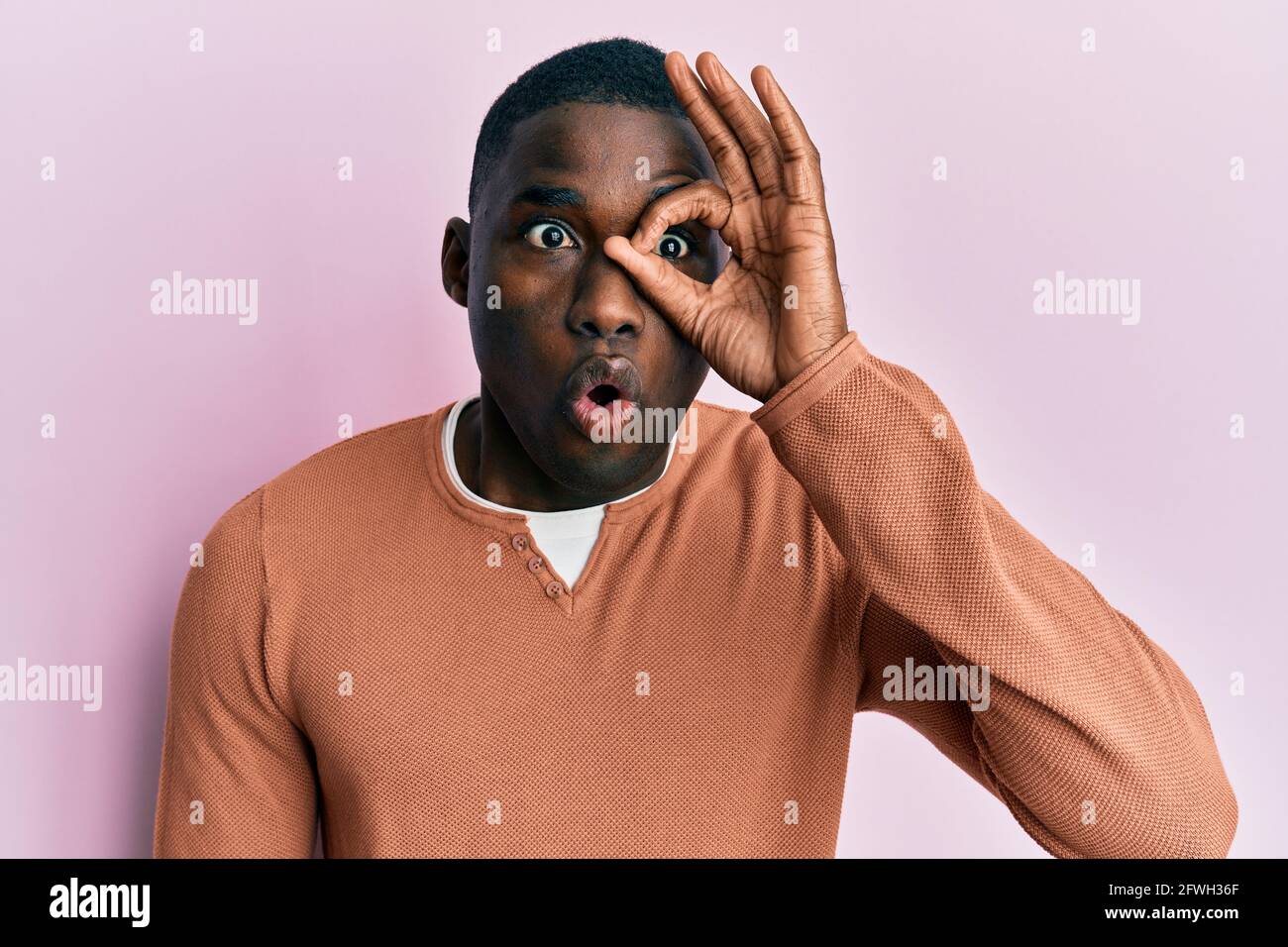 Young african american man wearing casual clothes doing ok gesture ...