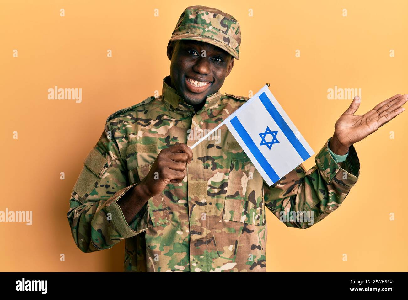 Young african american man wearing army uniform holding israel flag ...