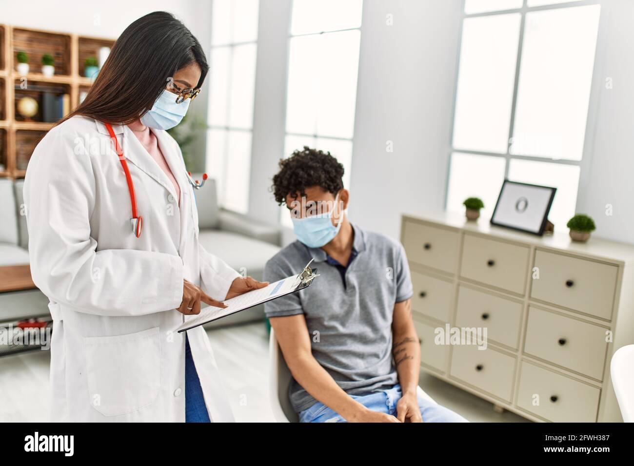 Young doctor woman reading patient checklist report Stock Photo - Alamy